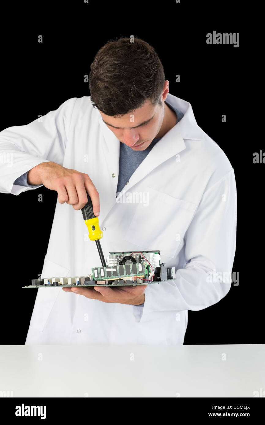 Attractive computer engineer repairing hardware at night Stock Photo ...