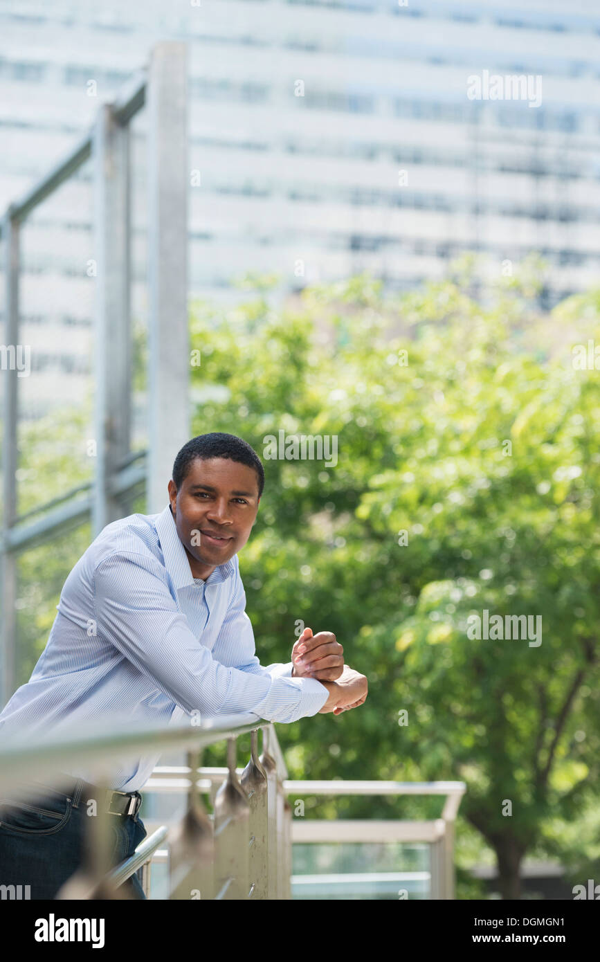 Summer. Business people. A man leaning on a railing relaxing. Off grid ...