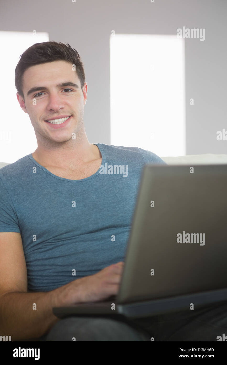 Man on couch with laptop hi-res stock photography and images - Alamy