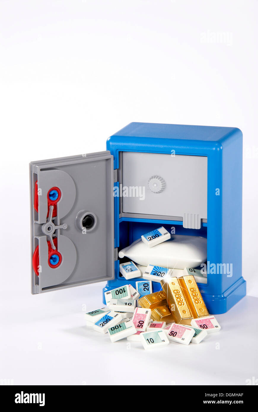 Money and gold in a toy safe, symbolic image Stock Photo - Alamy