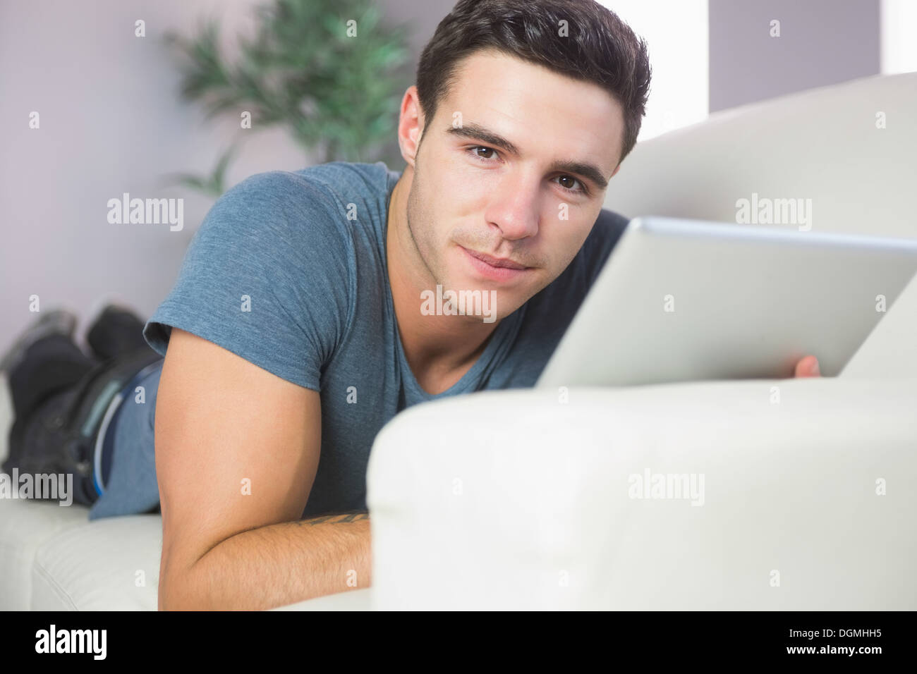 Young man lying on couch hi-res stock photography and images - Alamy