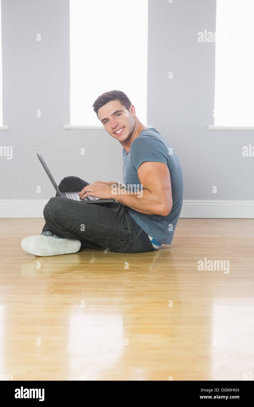 Smiling man sitting floor hi-res stock photography and images - Alamy