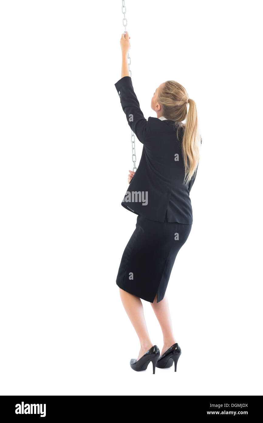 Ponytailed chic businesswoman pulling a chain Stock Photo - Alamy