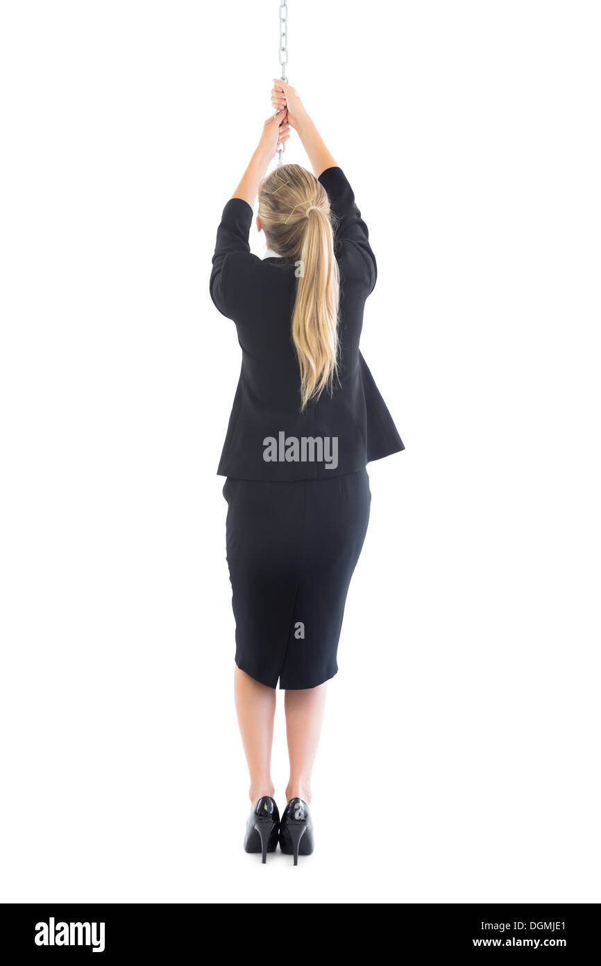 Rear view of young businesswoman pulling a chain Stock Photo - Alamy