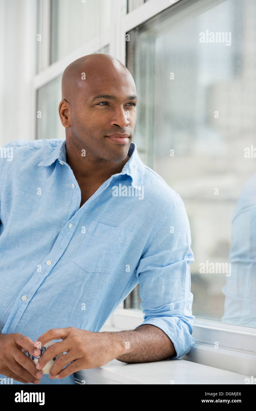 Man leaning out window hi-res stock photography and images - Alamy