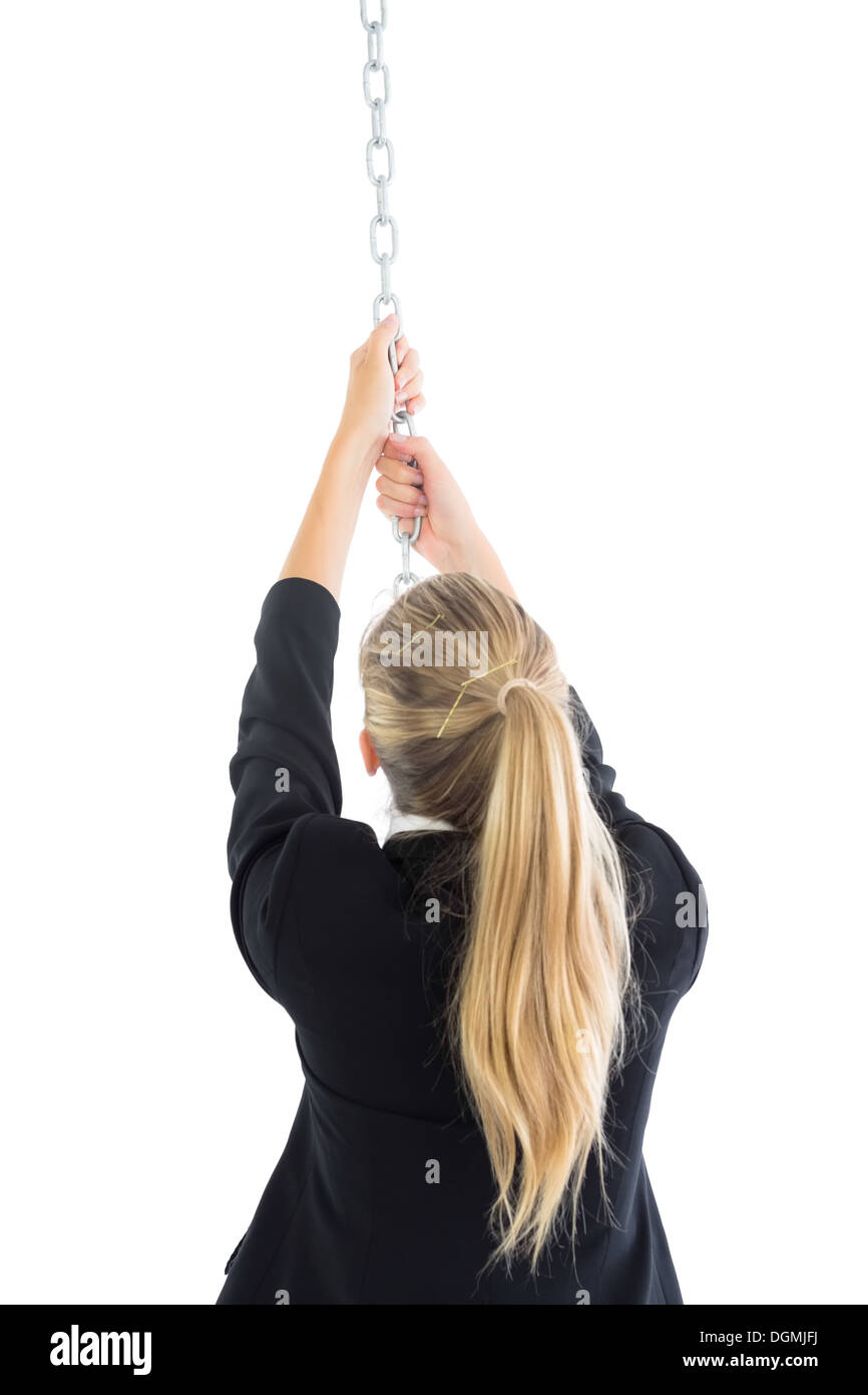 Rear view of blonde businesswoman pulling a chain Stock Photo - Alamy