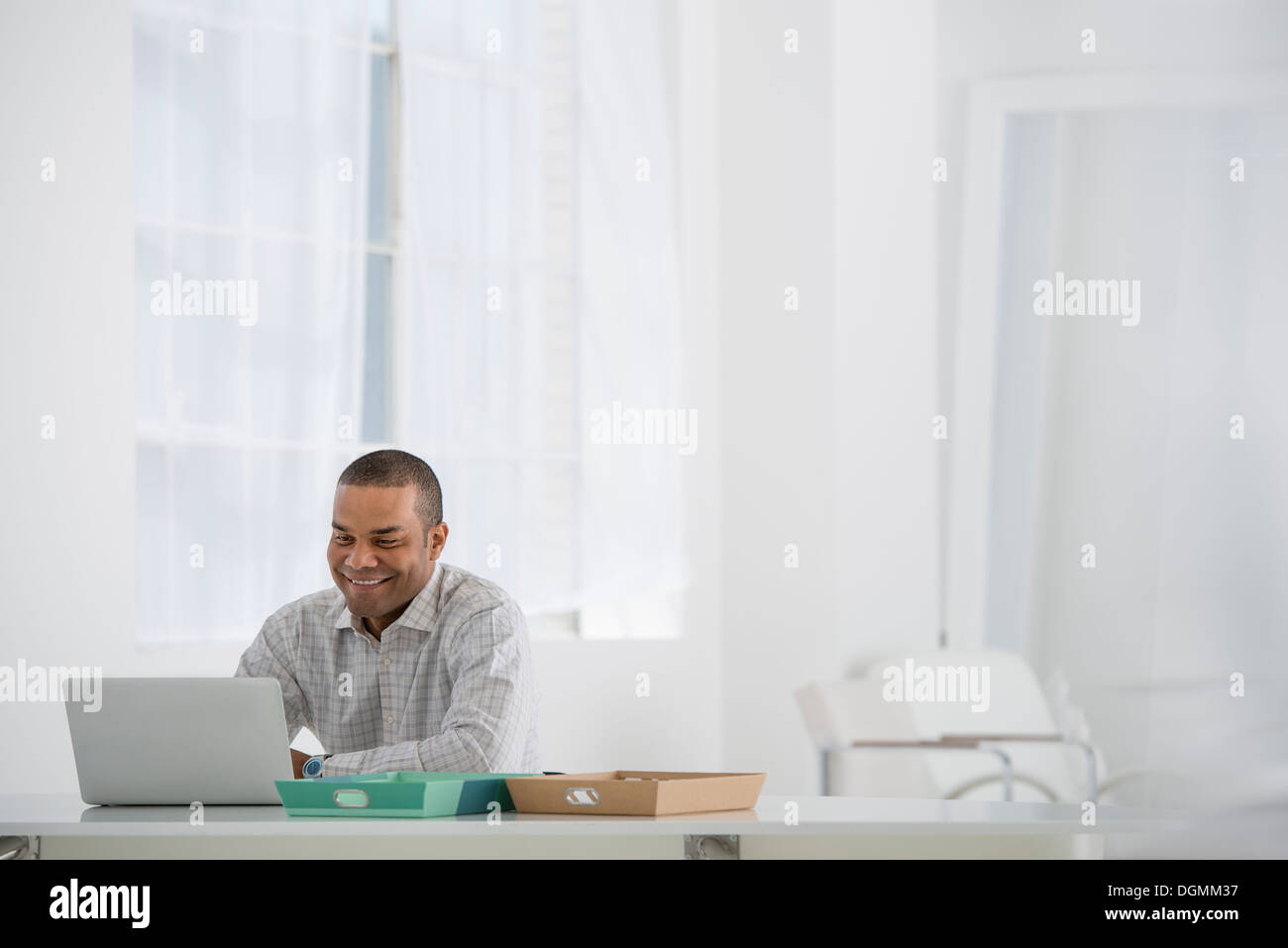 Man sitting desk using laptop hi-res stock photography and images - Alamy