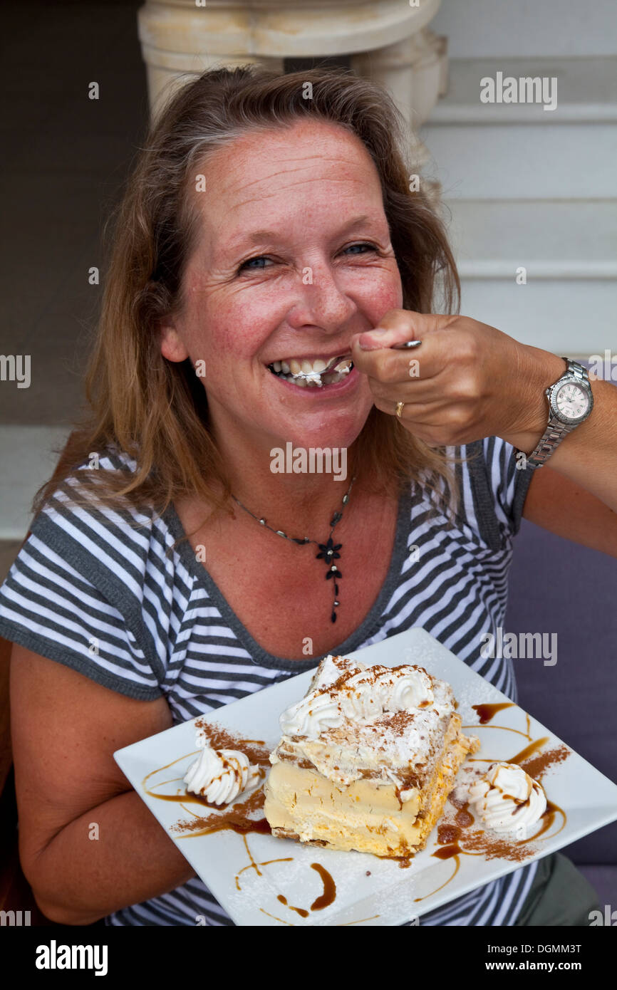 Middle Aged British Woman Eating A Large Cake, Tsilivi, Zakynthos ...