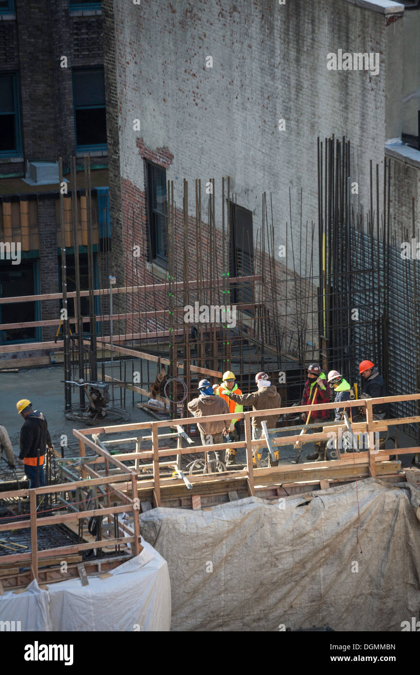 High-rise Building Construction Site, NYC with tradesmen Stock Photo ...