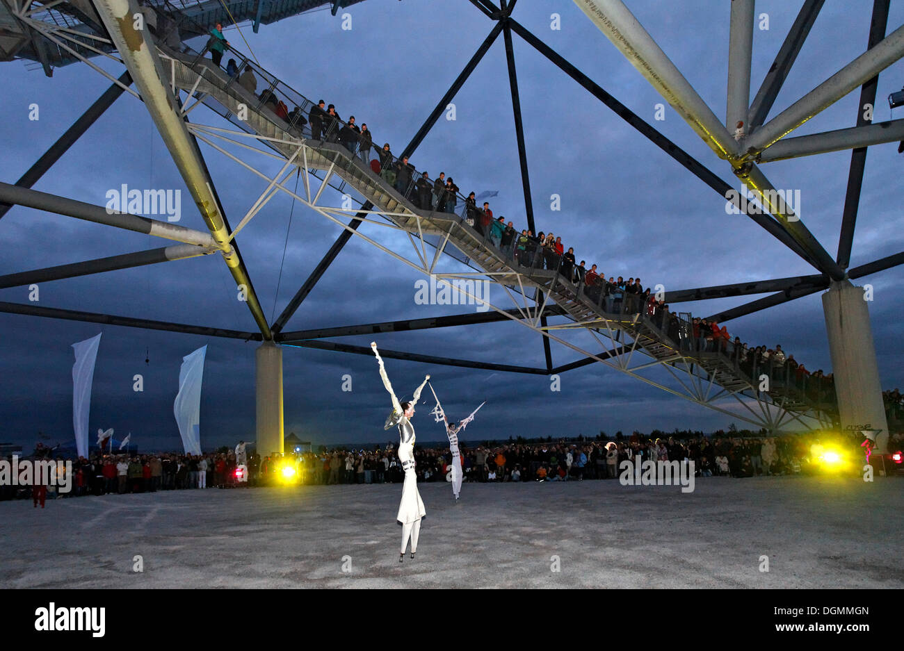 Two performers on stilts, summer night show at the tetrahedron ...