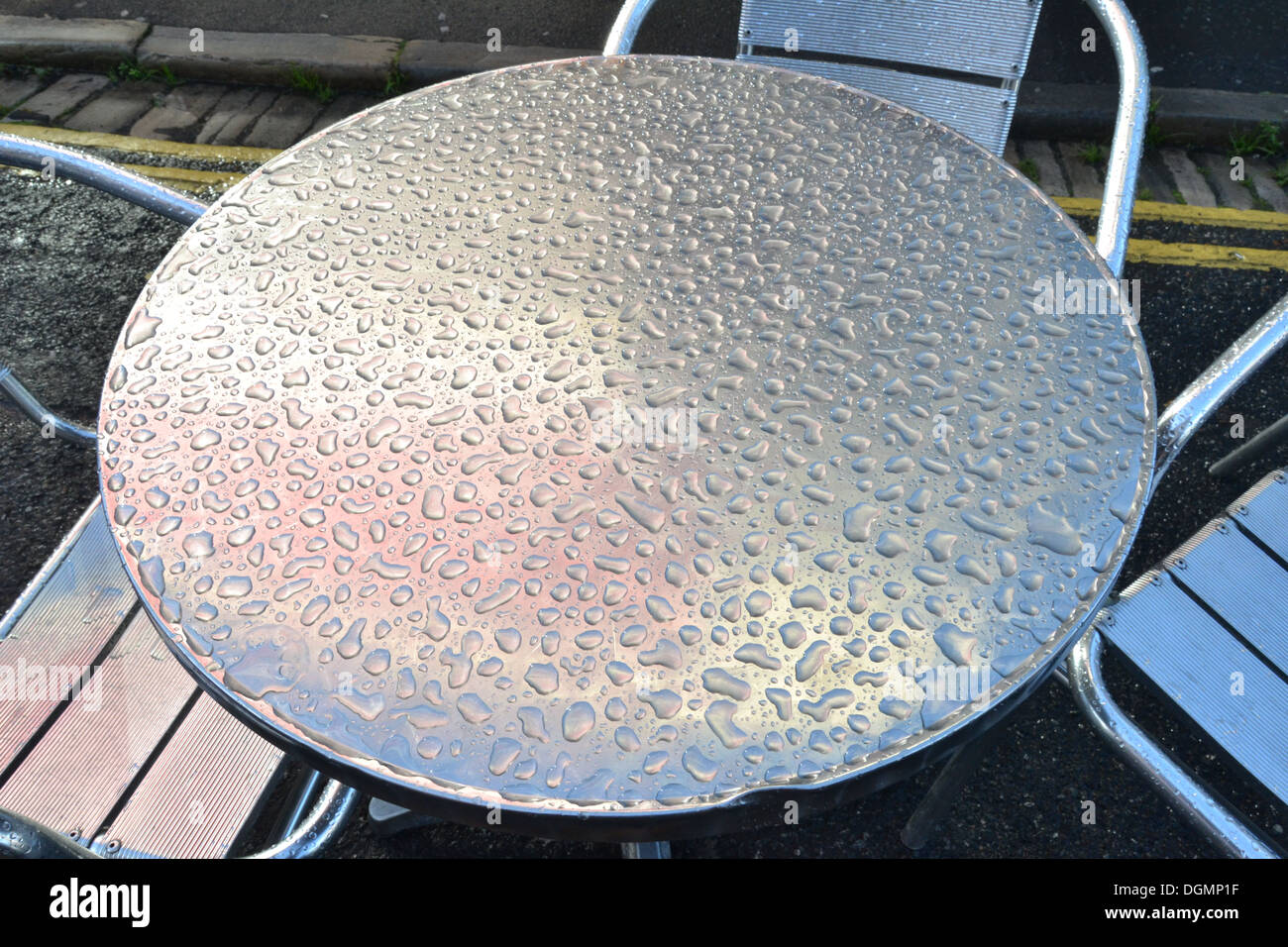 Rain droplets on a table with chairs Stock Photo - Alamy