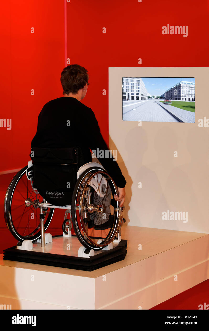 Child sitting in a wheelchair in front of a screen, disability ...