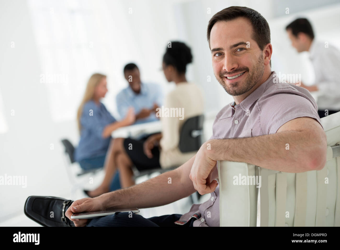 Office interior. Meeting. One person looking over his shoulder and away ...