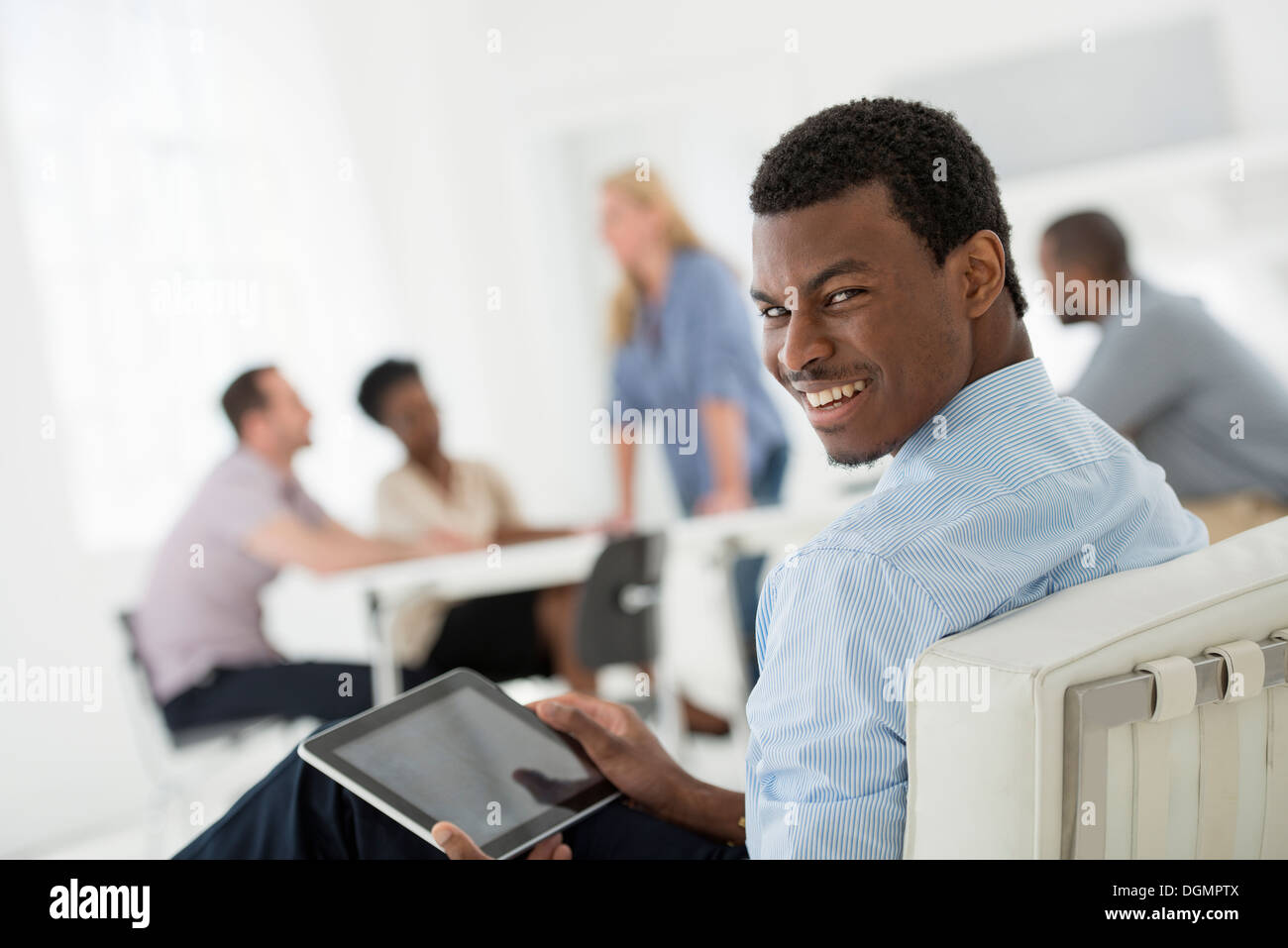 Office interior. Meeting. One person looking over his shoulder and away ...