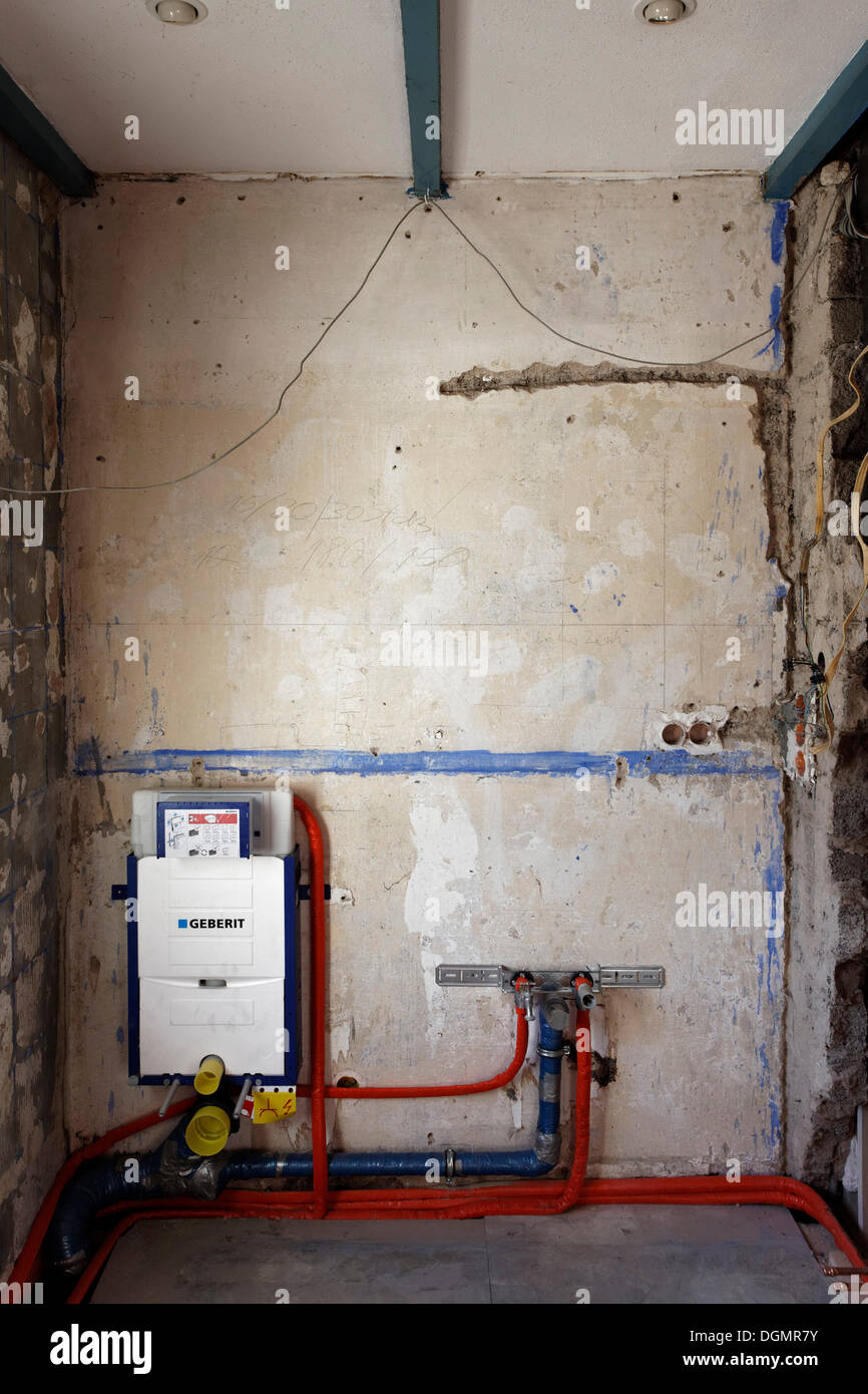 New plumbing lines and WC cistern in an old bathroom, bathroom ...