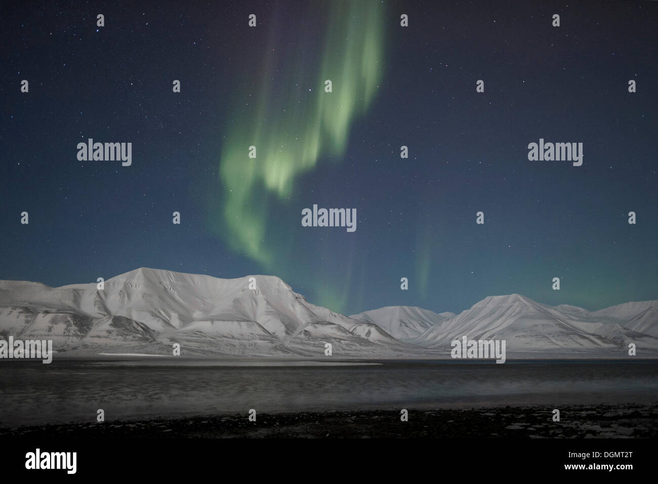 Green Northern Lights, Aurora Borealis, over the mountains of ...
