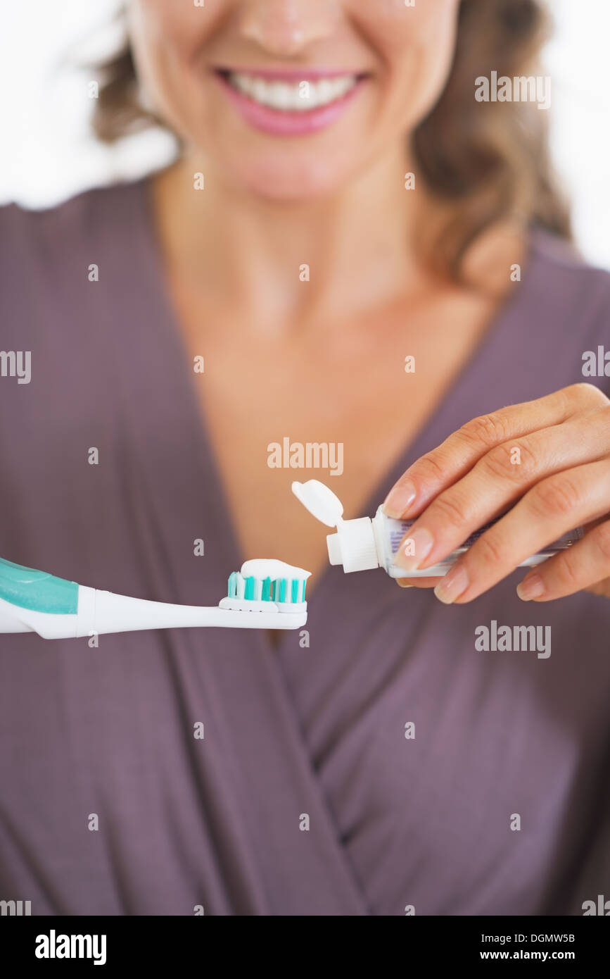 Closeup on young woman squeezing toothpaste from tube Stock Photo - Alamy