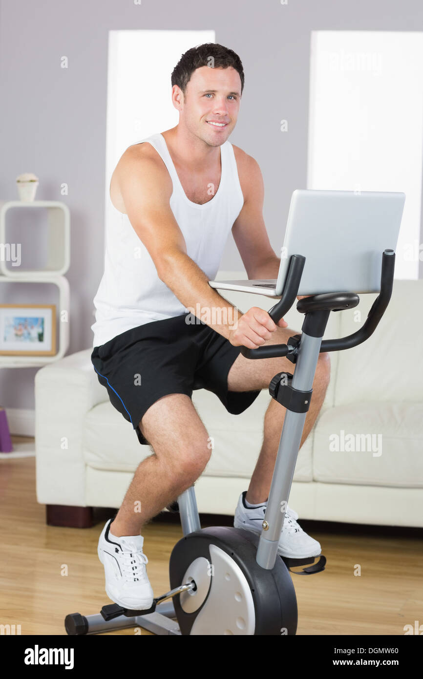 Muscular man holding laptop hi-res stock photography and images - Alamy
