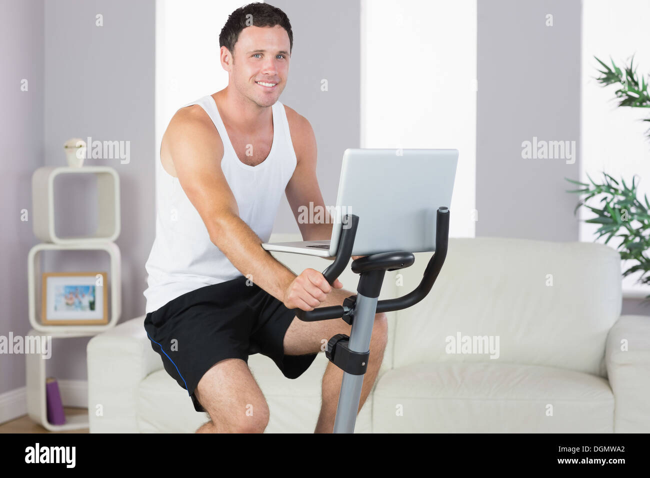 Muscular man holding laptop hi-res stock photography and images - Alamy