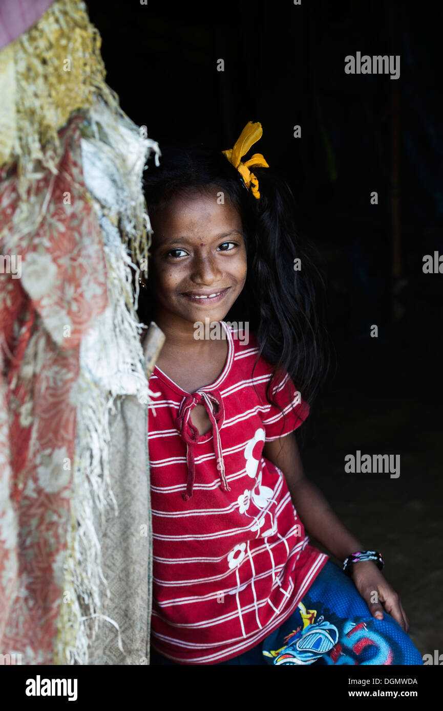 Happy smiling Indian lower caste girl standing inside her bender / tent ...