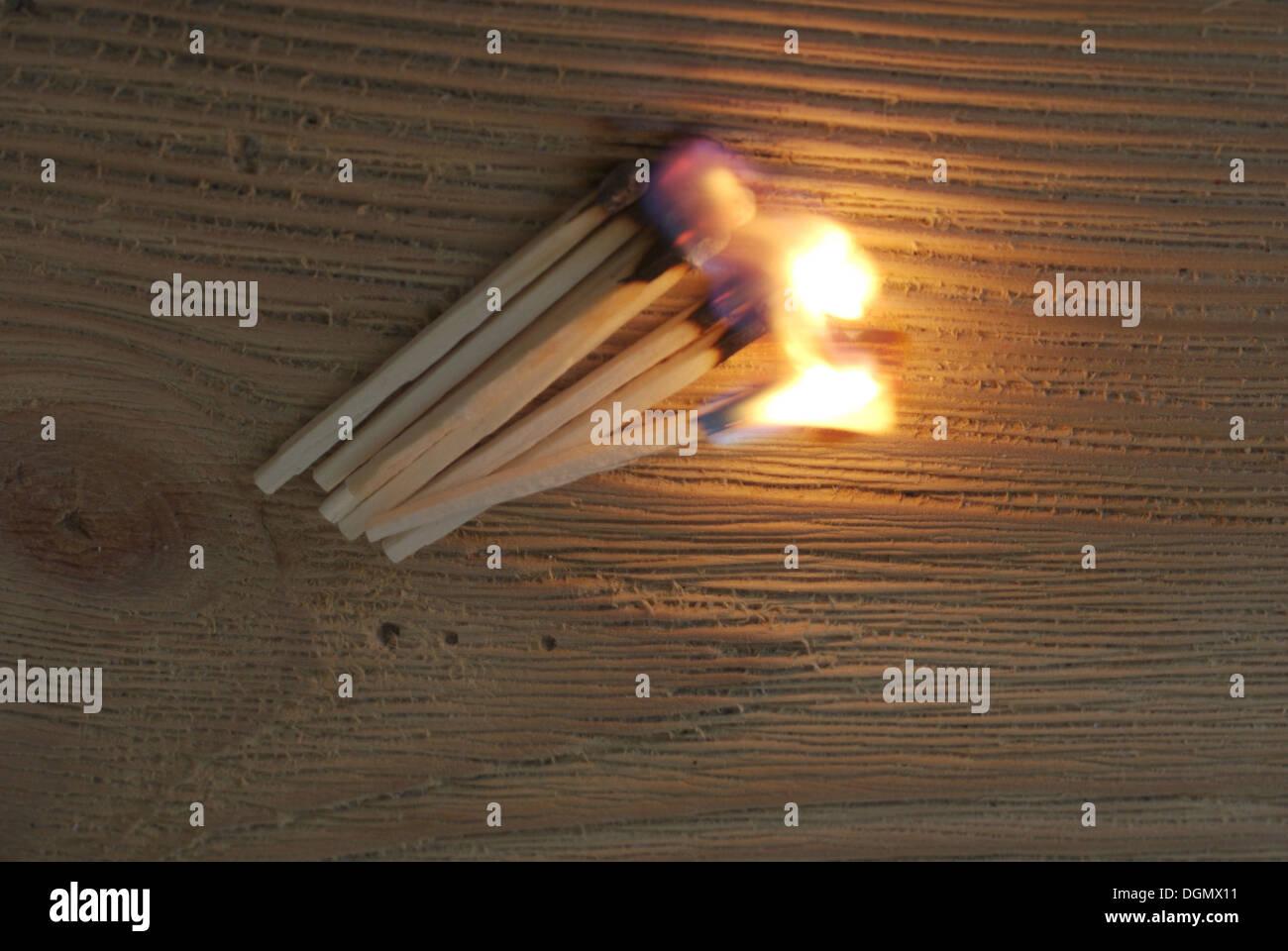 several burning matches on background of old wood Stock Photo - Alamy
