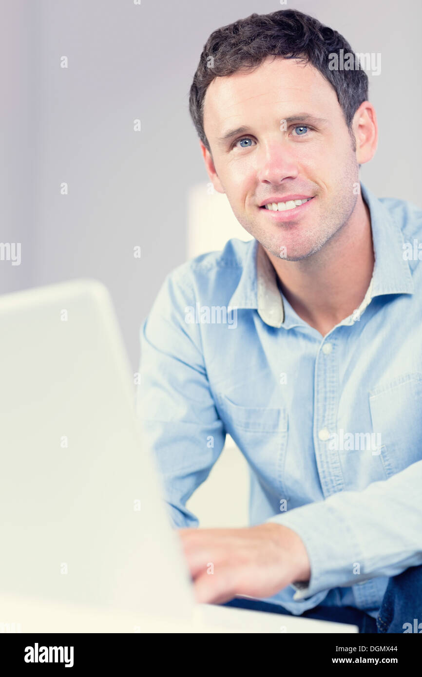 Man laptop looking at camera home hi-res stock photography and images ...