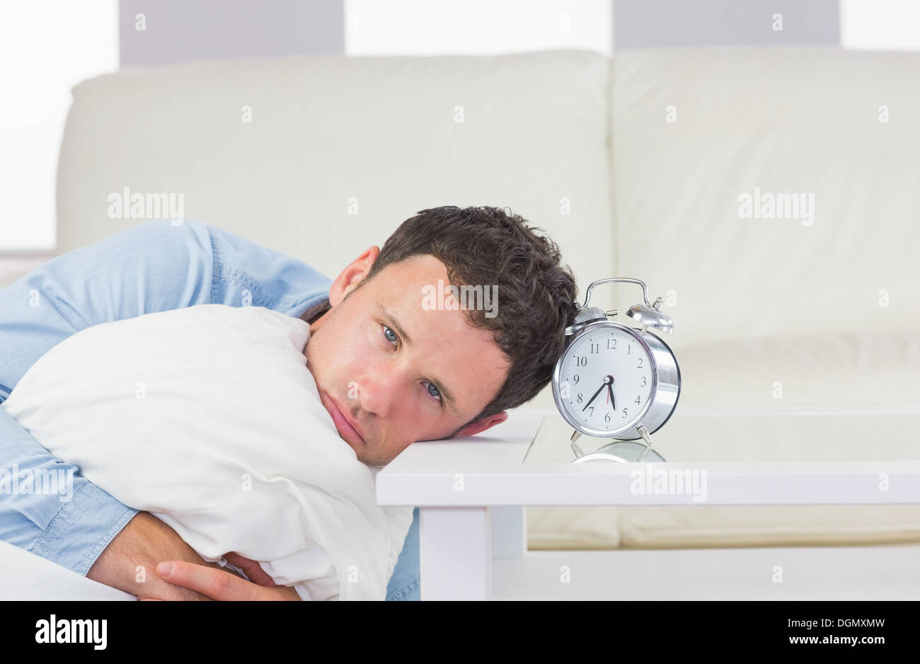 Troubled casual man resting head on table Stock Photo - Alamy