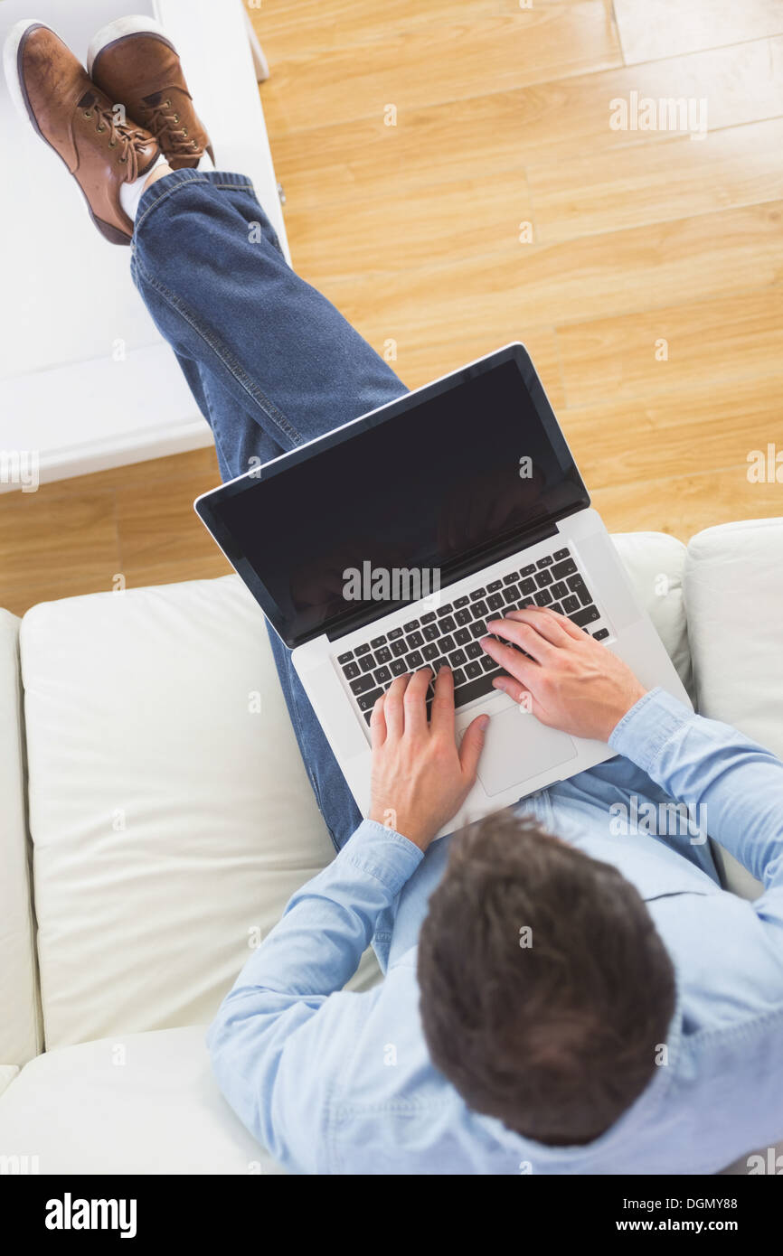 Laptop feet up coffee table hi-res stock photography and images - Alamy