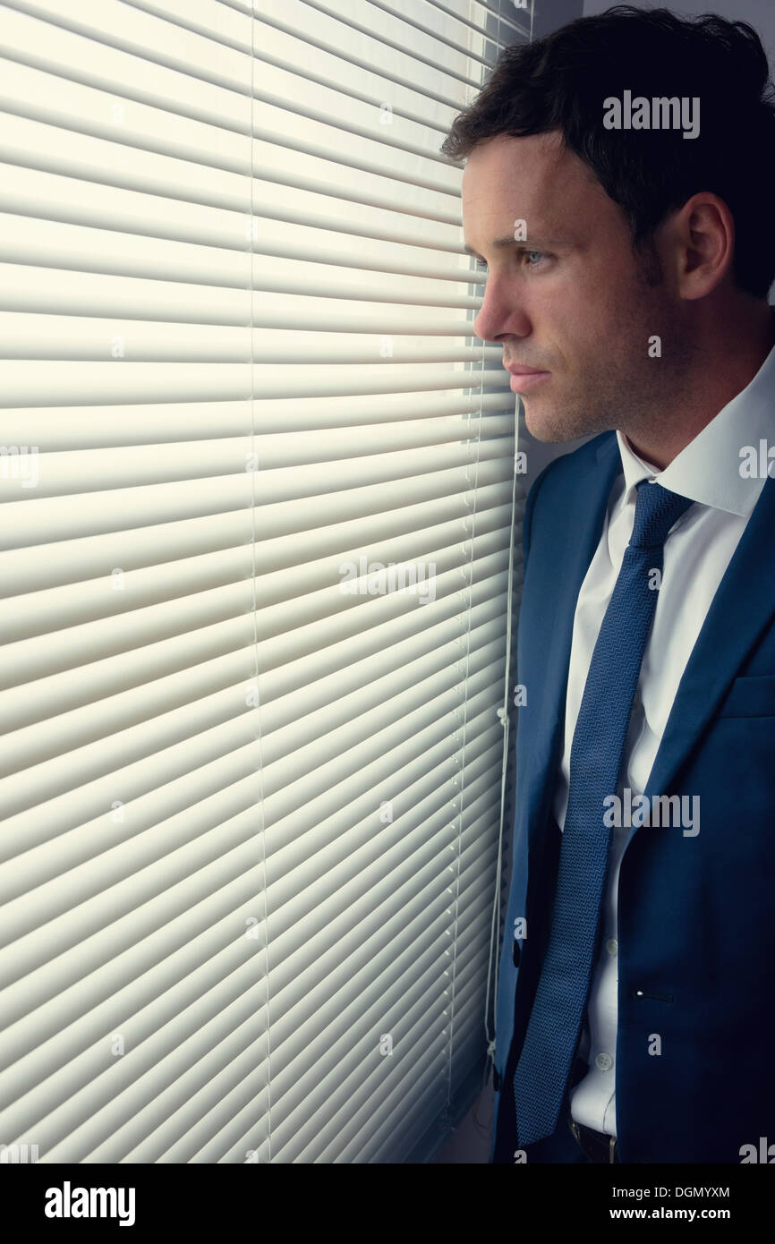 Man peeking out window hi-res stock photography and images - Alamy