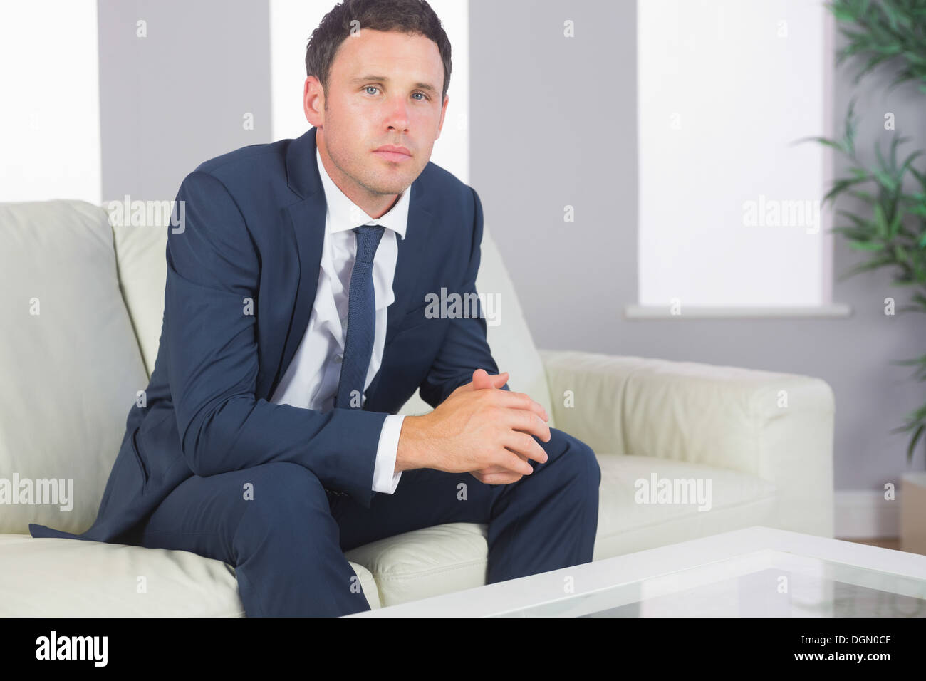 Calm handsome businessman relaxing on couch Stock Photo - Alamy
