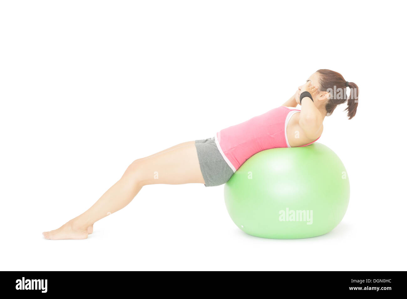 Attractive sporty brunette doing sit ups on exercise ball Stock Photo ...
