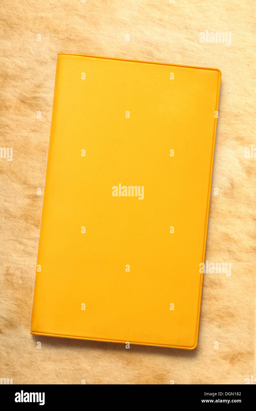 Yellow blank book on stained paper Stock Photo - Alamy