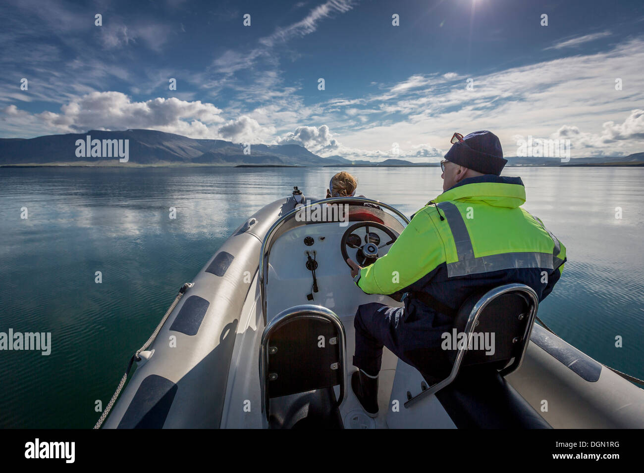 Traveling on a small boat in the Reykjavik Harbor with Mt Esja in the ...