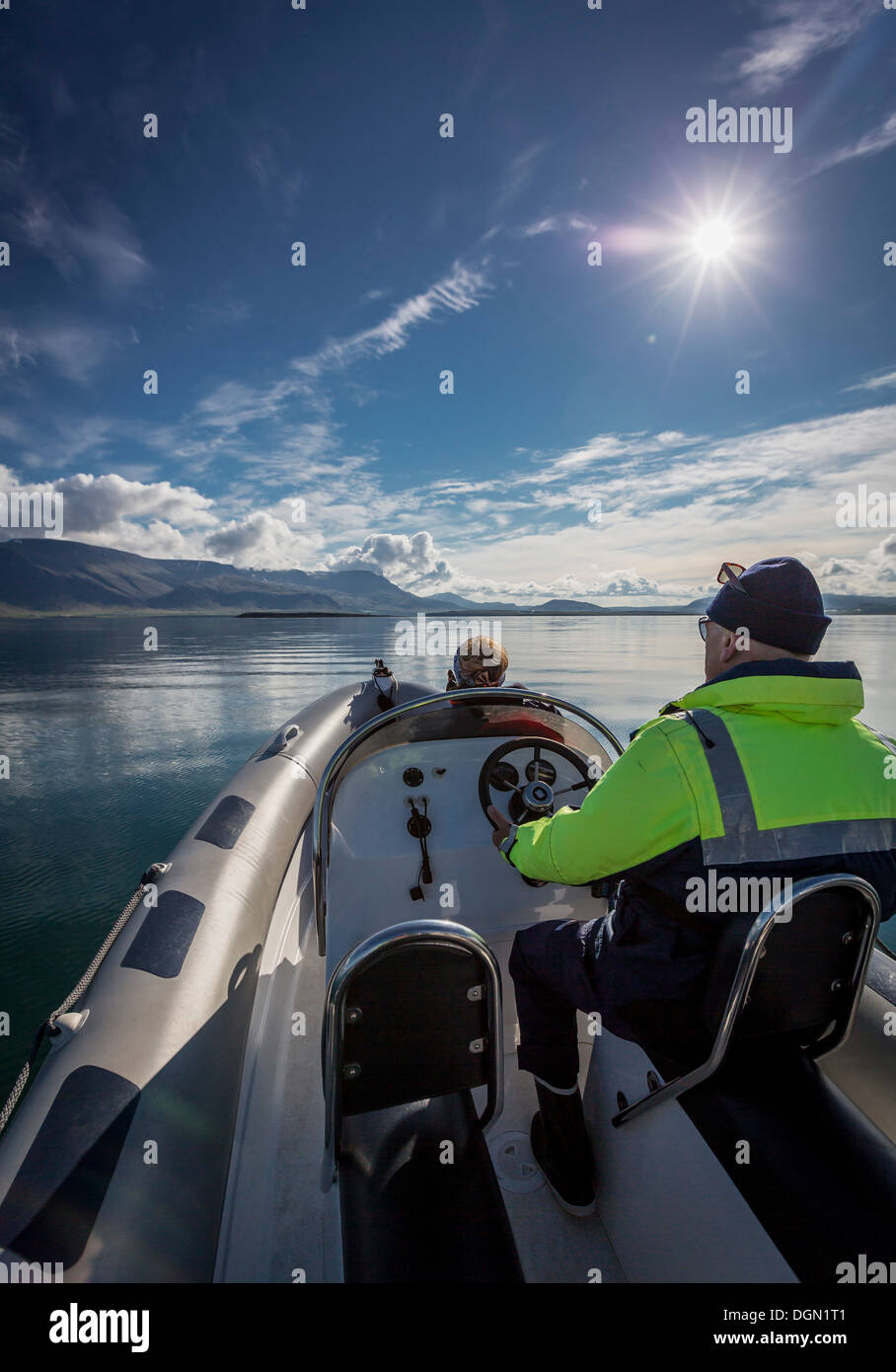 Traveling on a small boat in the Reykjavik Harbor with Mt Esja in the ...