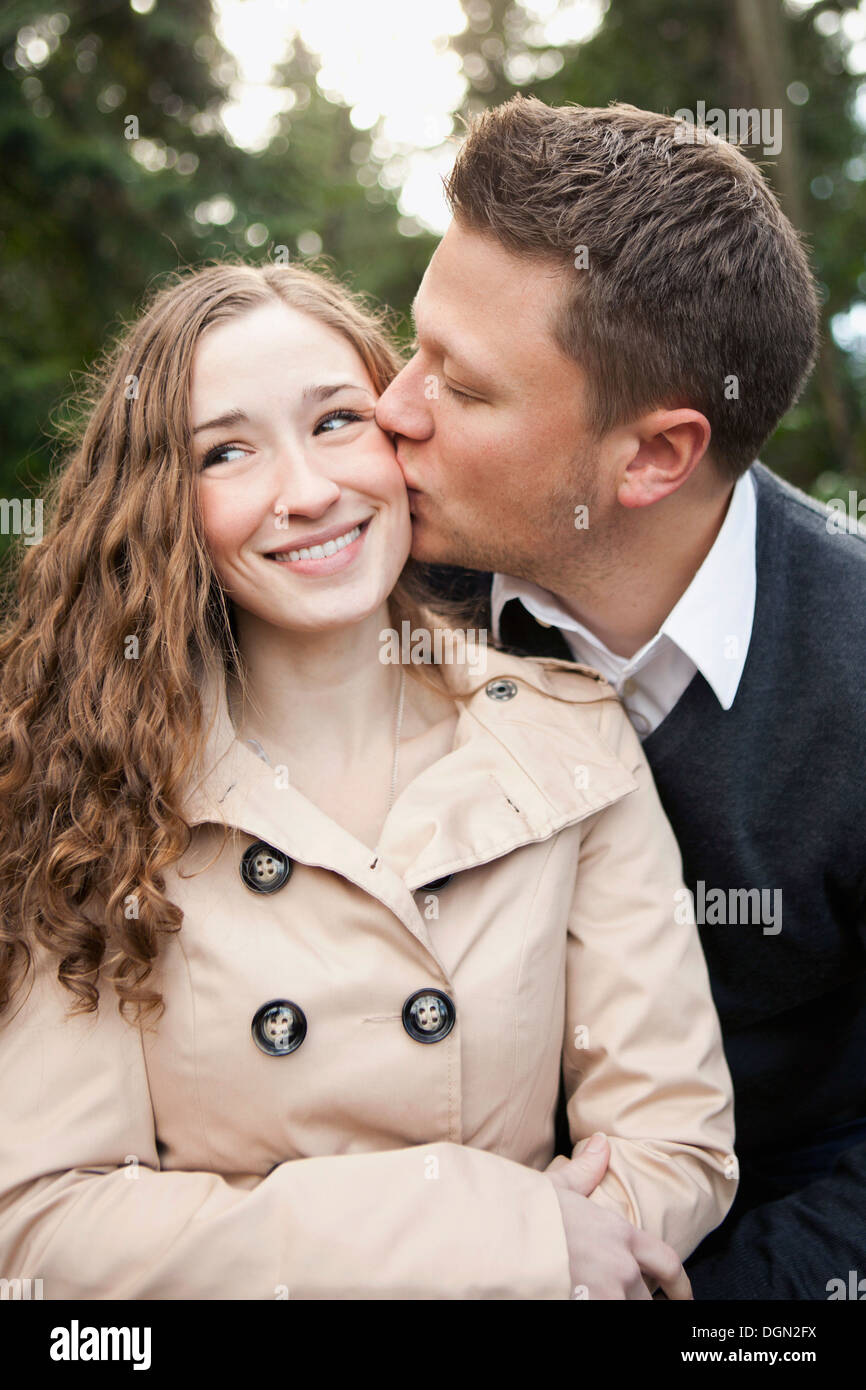 Young couple kissing Stock Photo - Alamy