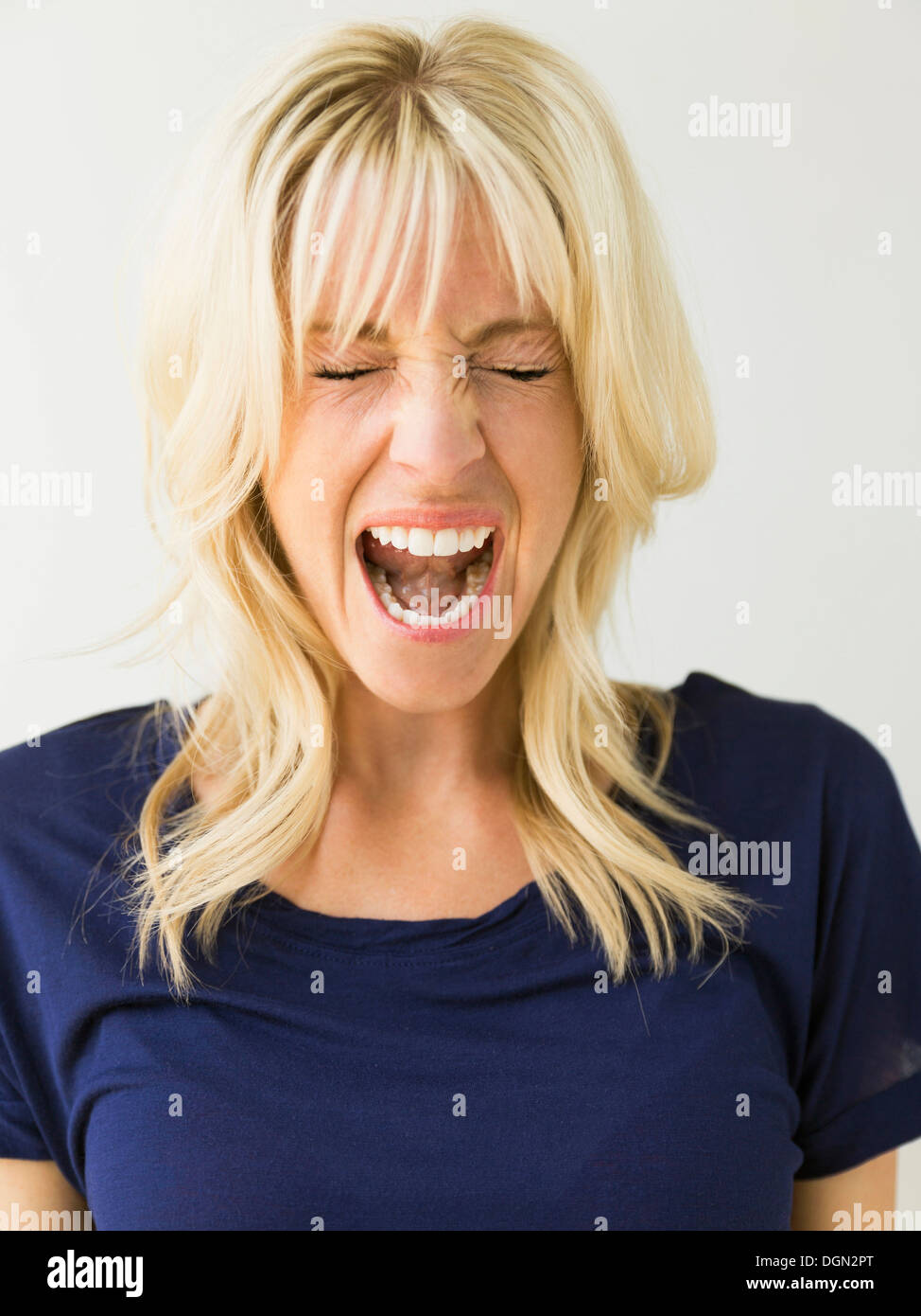 Studio portrait of blonde woman screaming Stock Photo - Alamy