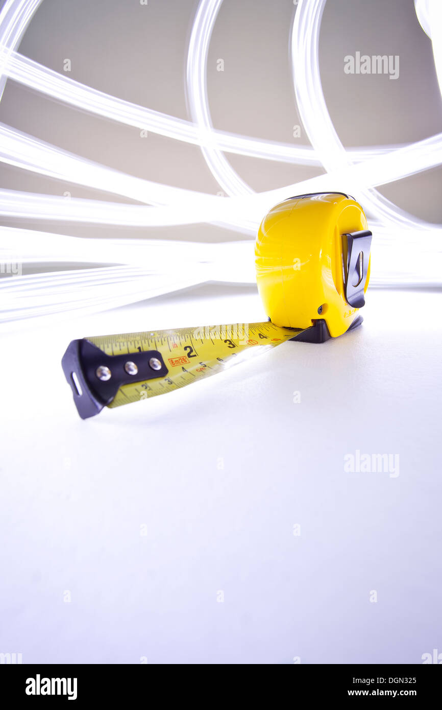Bright yellow tape measure with light streaks Stock Photo - Alamy