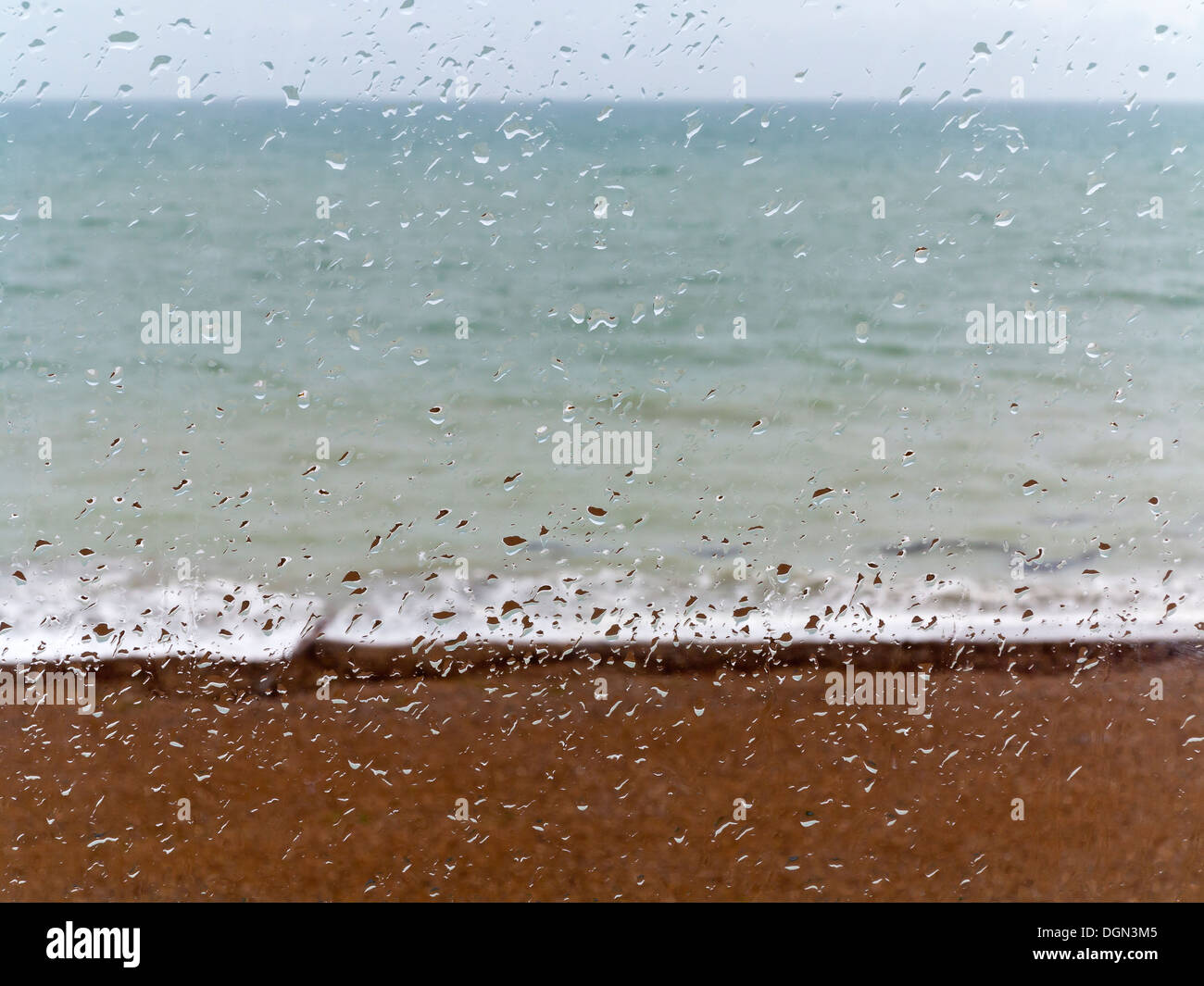 A close up of the sea in soft focus breaking onto a beach taken through ...