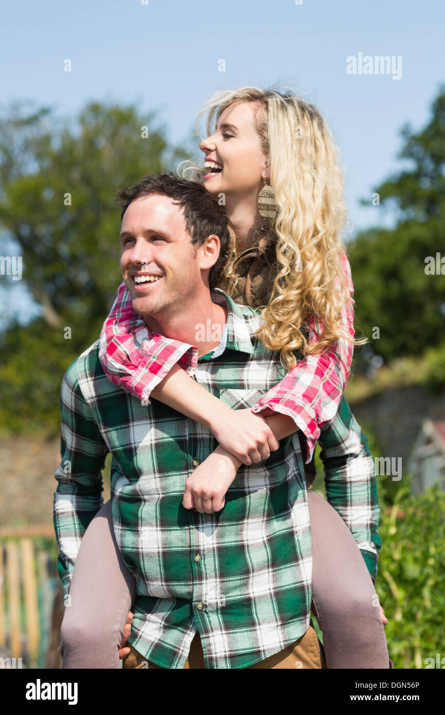 Man giving his beautiful girlfriend a piggyback ride Stock Photo - Alamy