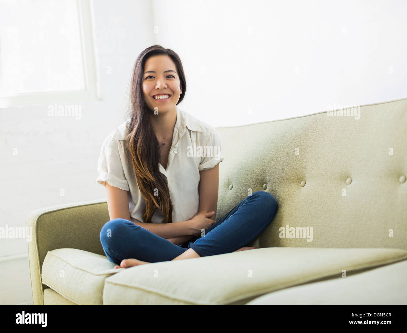 Casual woman sitting on sofa hi-res stock photography and images - Alamy
