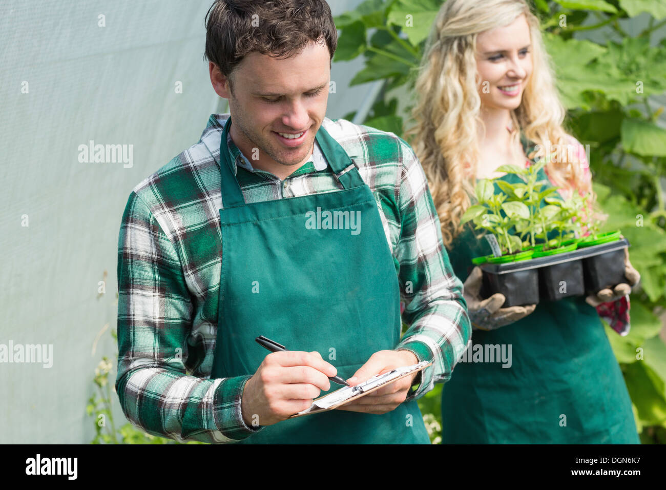 Smiling man using a clipboard Stock Photo - Alamy