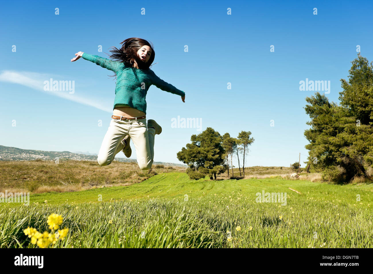 Teenage girl enjoying springtime in the field Stock Photo - Alamy