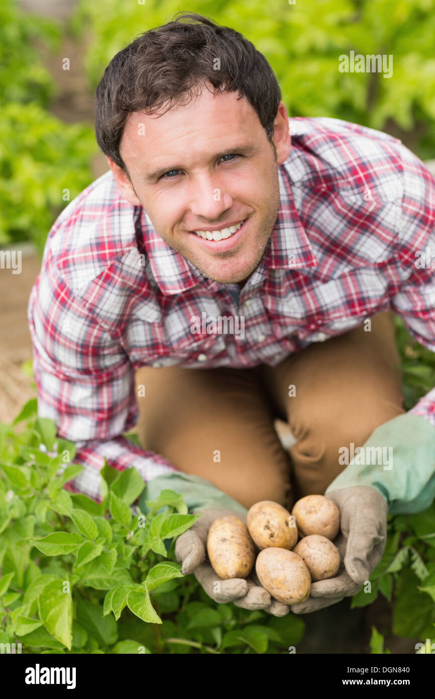 Young man holding some potatoes Stock Photo - Alamy