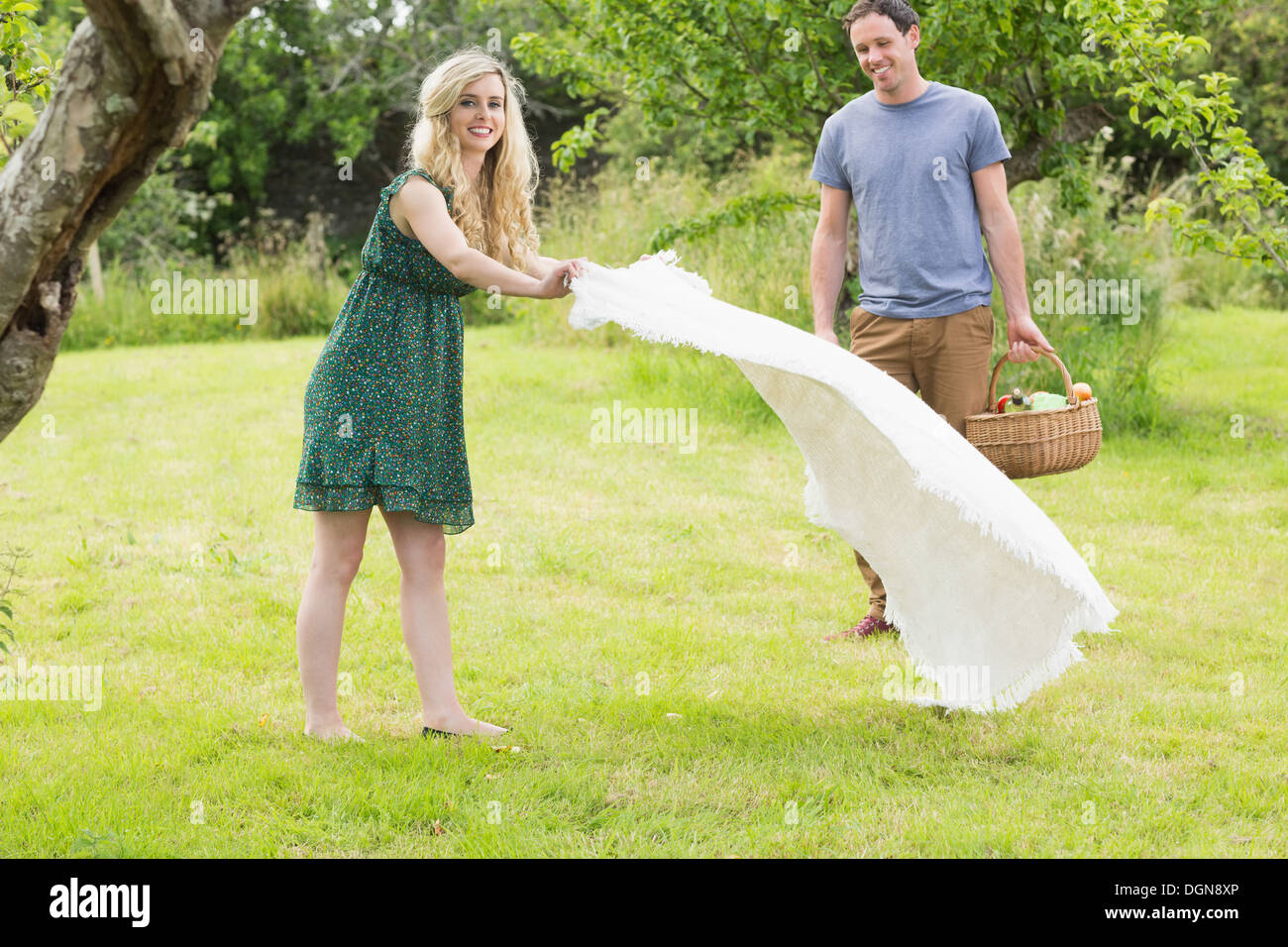 A young man holding a basket with a blanket hi-res stock photography ...