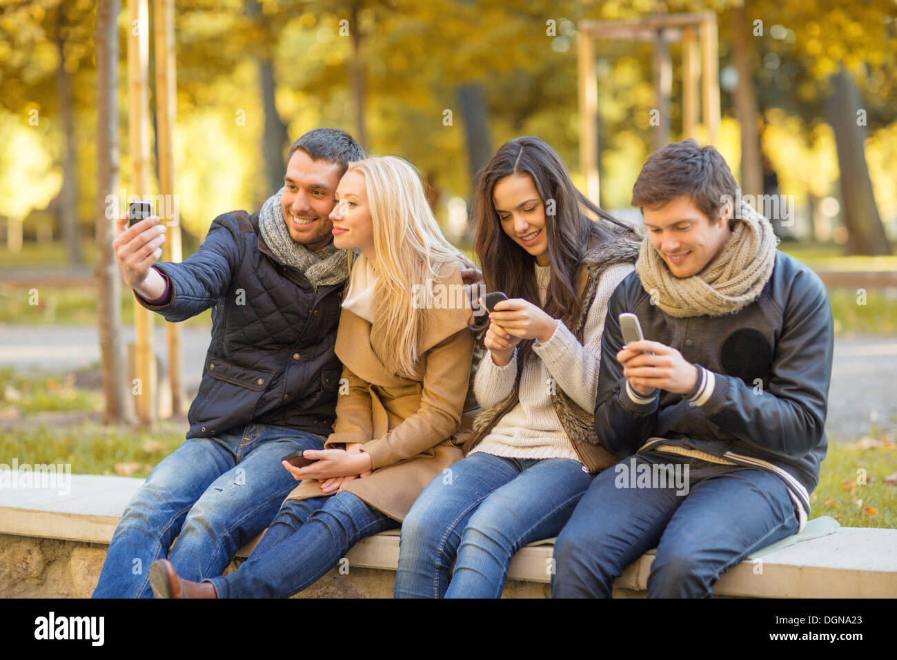 group of friends having fun in autumn park Stock Photo - Alamy
