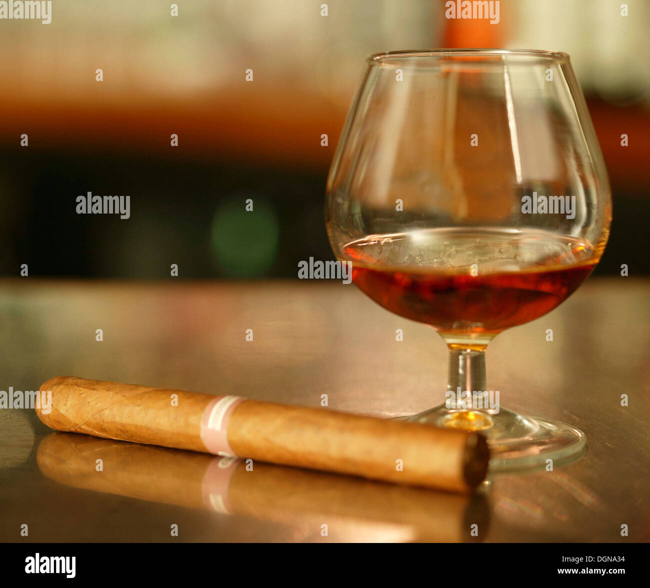 A glass of brandy and a cigar on a bar Stock Photo - Alamy