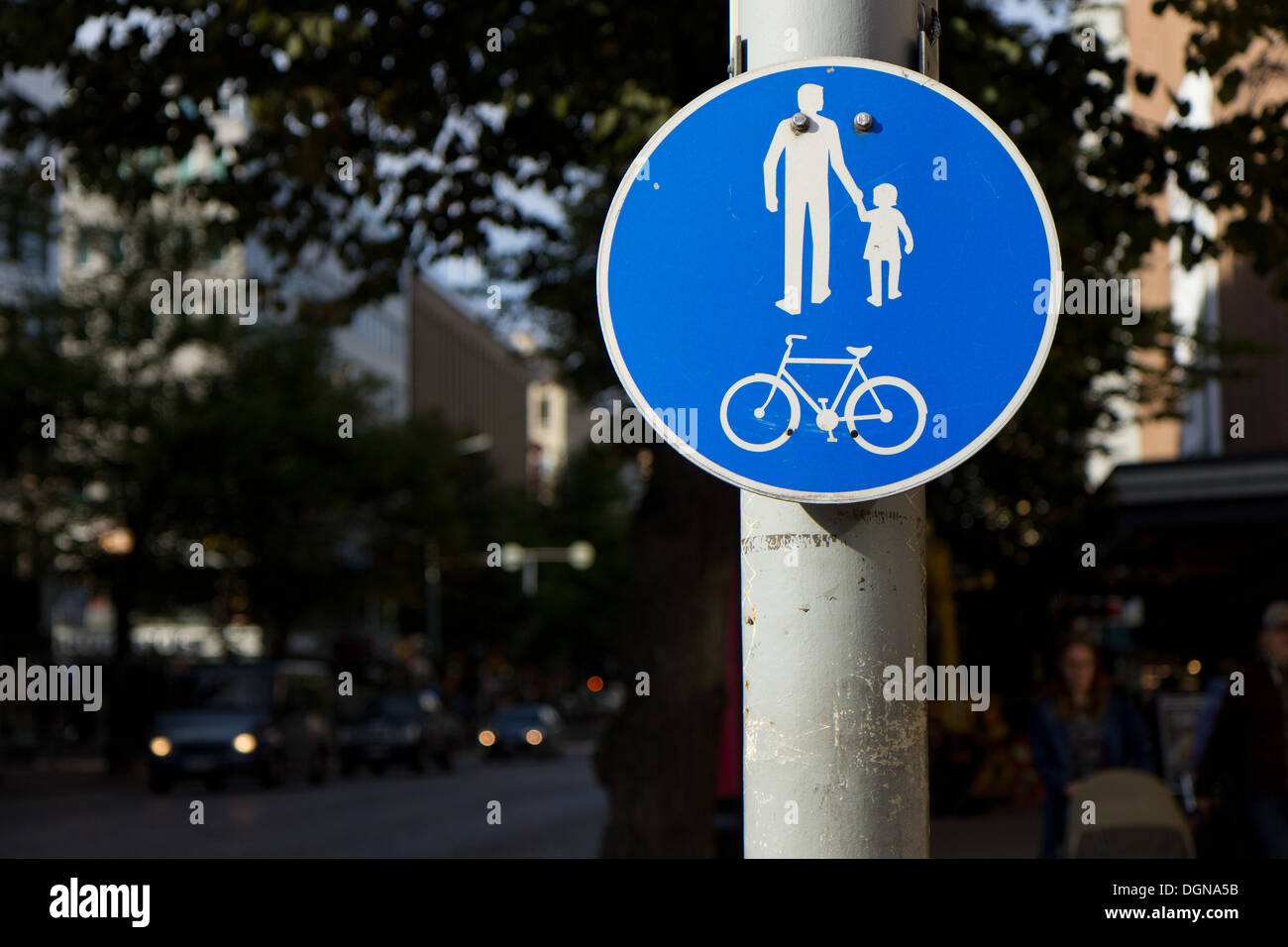 Blue and white traffic sign on a pole indicating footpath for ...