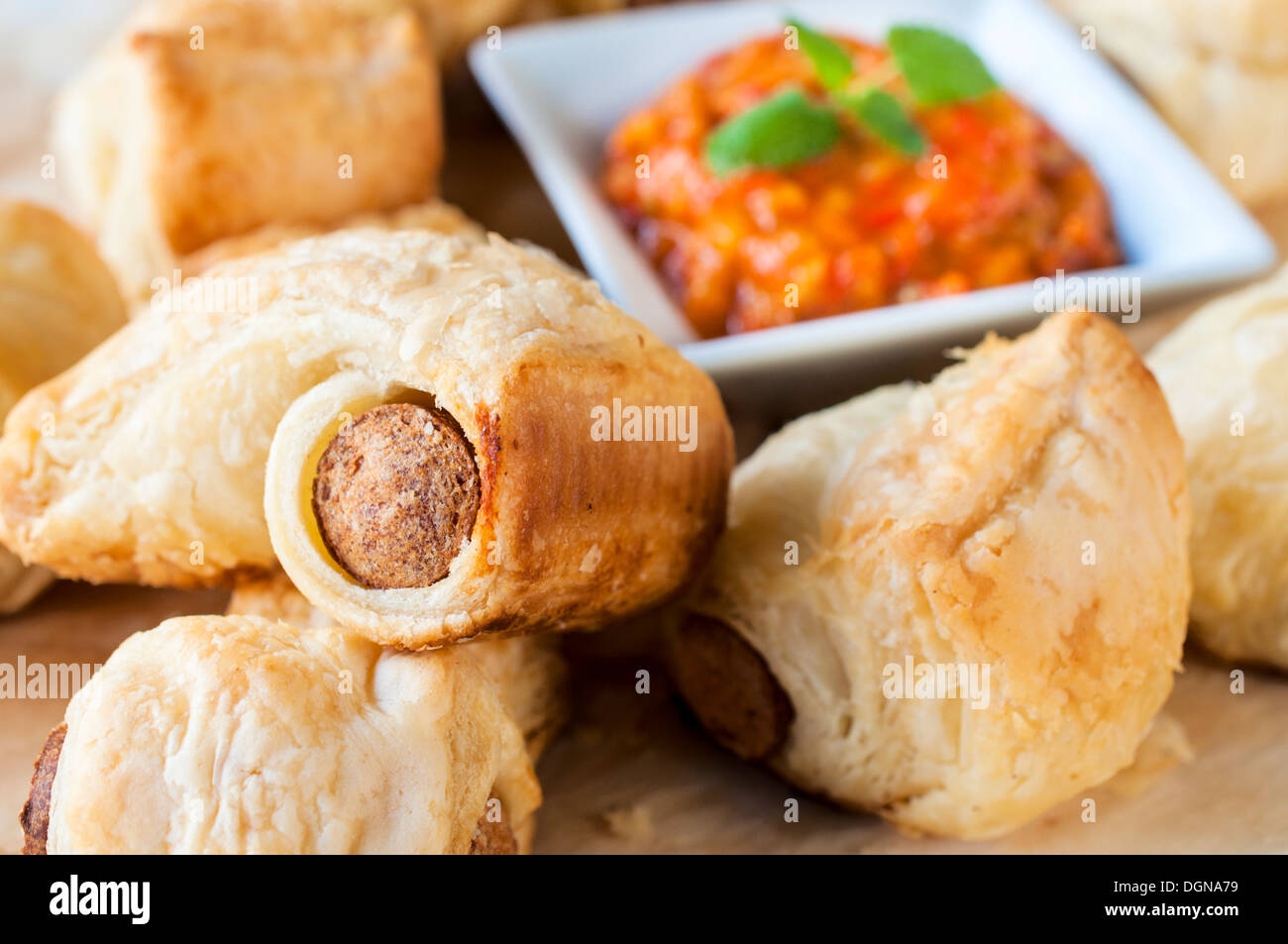 Mini sausage pastry with the pepper salad in background Stock Photo - Alamy