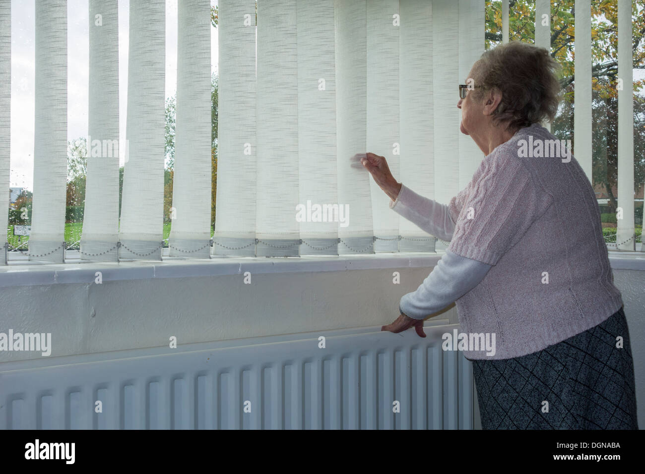 Elderly lady looking out window hi-res stock photography and images - Alamy