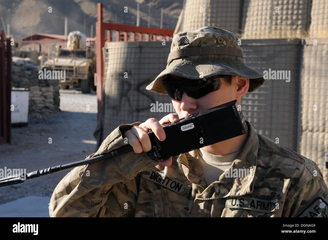 U.S. Army Sgt. Michael Dighton radios to his Soldier while working to ...